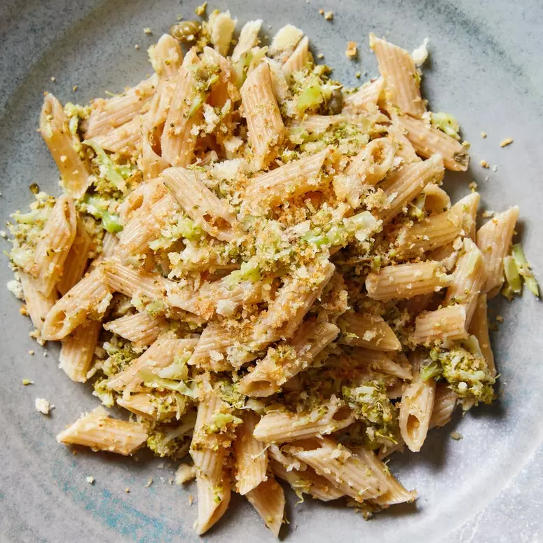 penne pasta toppad med broccoli bitar och ströbröd
